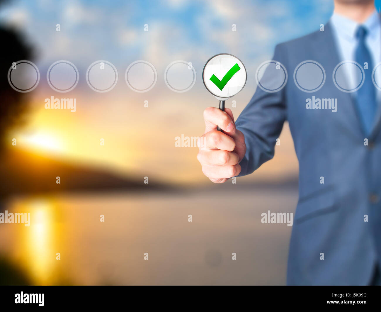 Businessman magnifying glass check mark on virtual screen. Magnifying ...