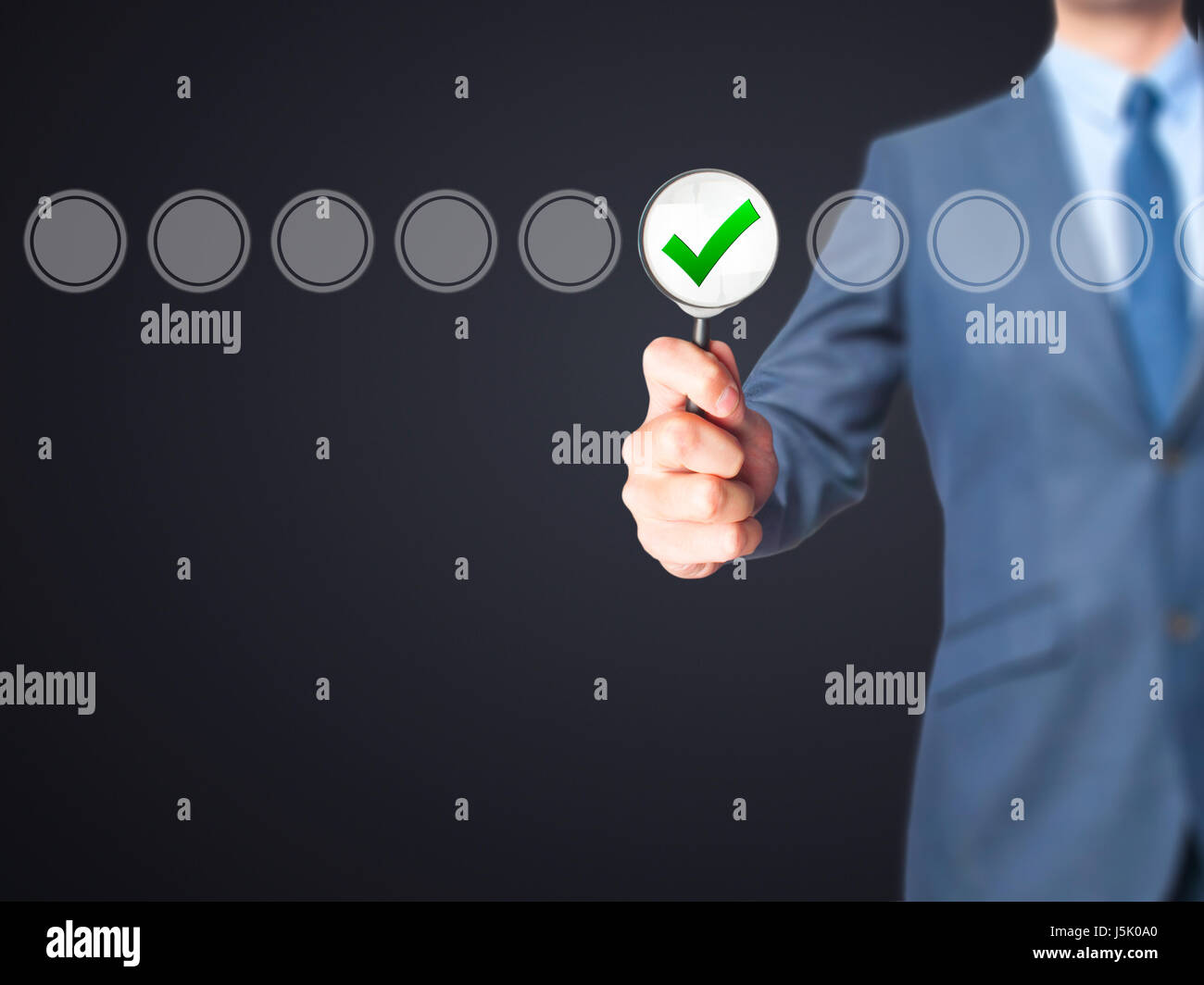 Businessman magnifying glass check mark on virtual screen. Magnifying ...