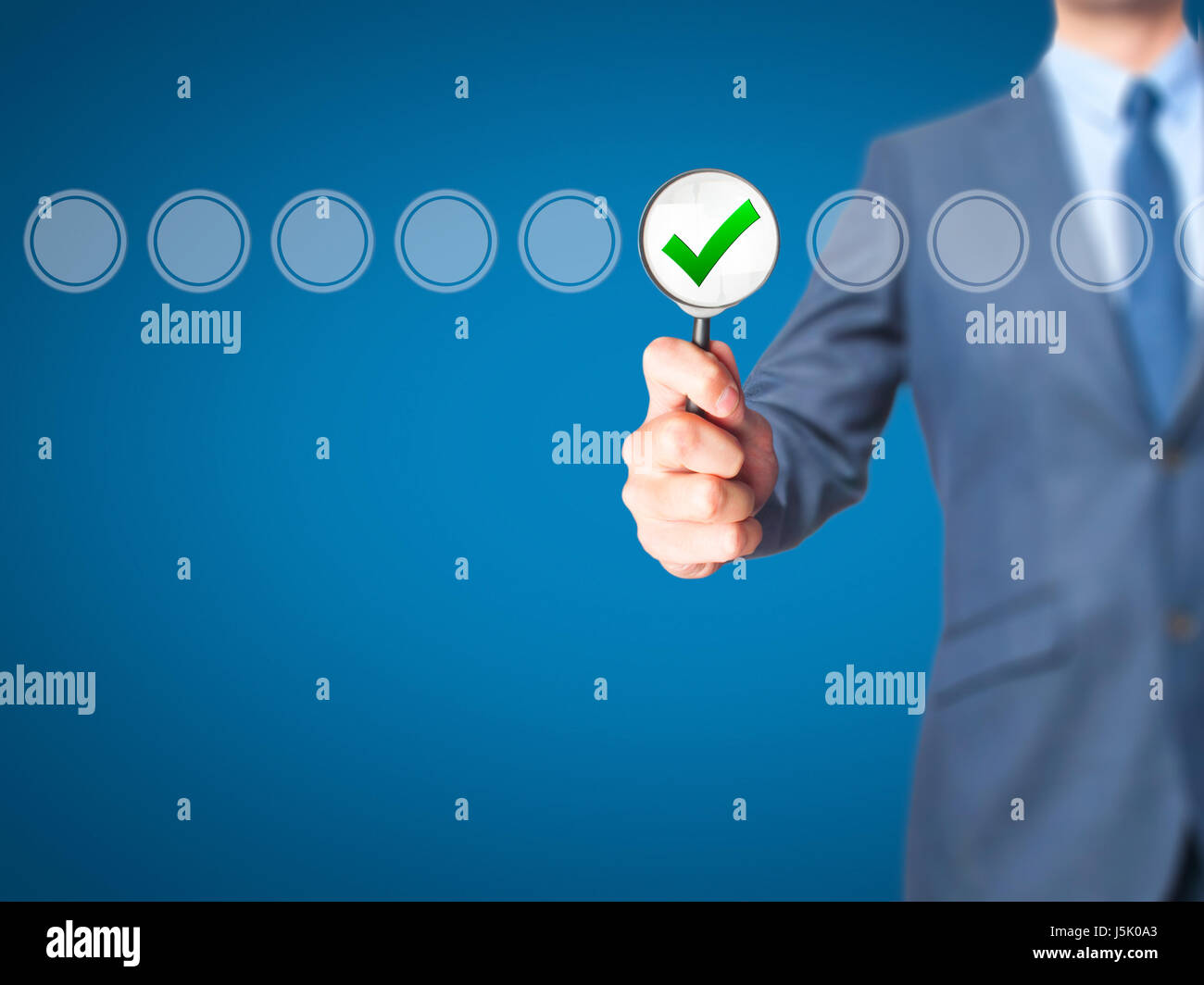 Businessman magnifying glass check mark on virtual screen. Magnifying ...