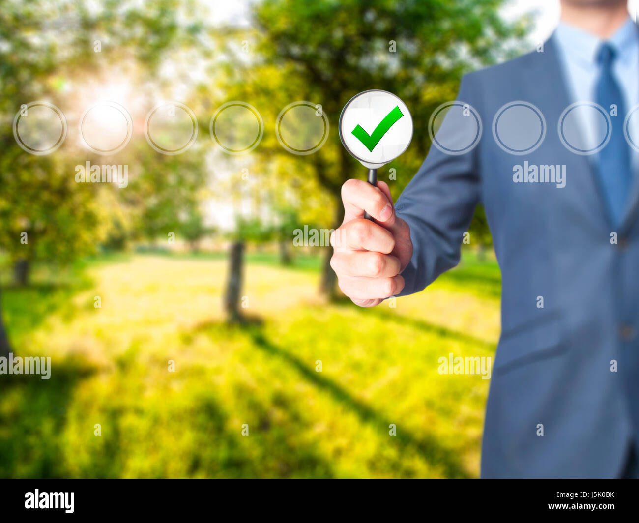 Businessman magnifying glass check mark on virtual screen. Magnifying ...