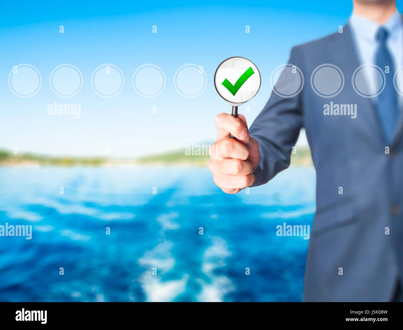 Businessman magnifying glass check mark on virtual screen. Magnifying ...