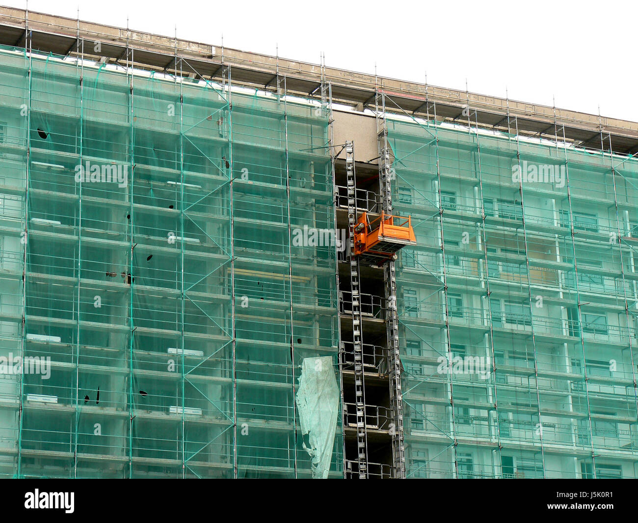 high-rise safety scaffold and hoist Stock Photo - Alamy