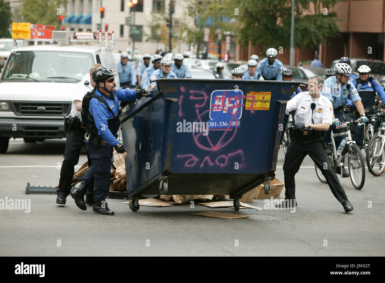 Police set upright a dumpster turned over by Black Bloc Anarchists ...