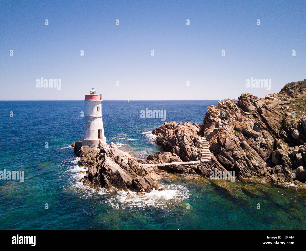 Aerial view of the Italian coast at sunset With a lighthouse on the ...