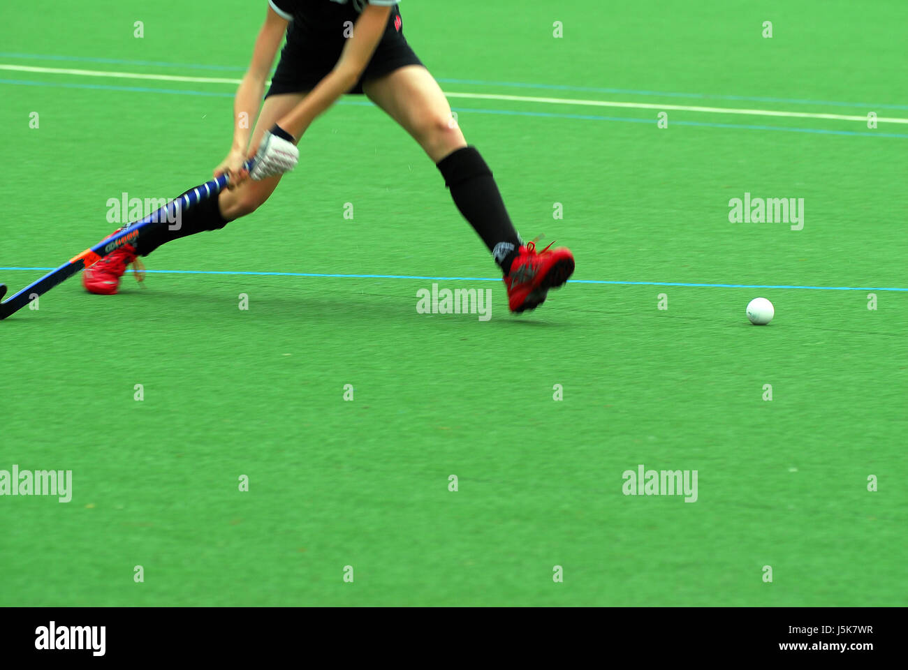 legs green hockey rackets churl motion blur hit balls shots ball ...