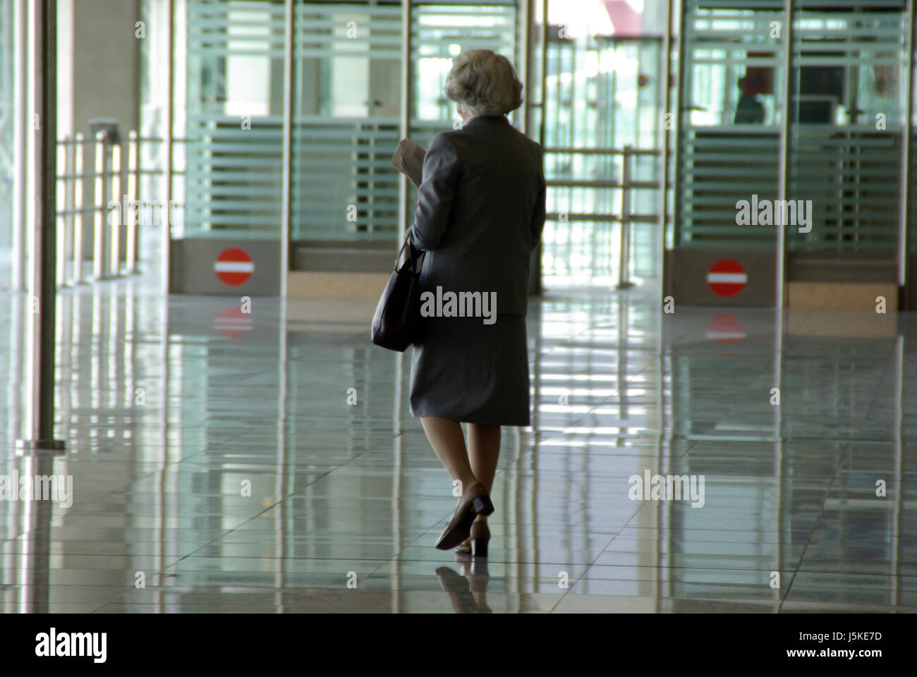 woman newspaper journal wait waiting handbag walk go going walking ...