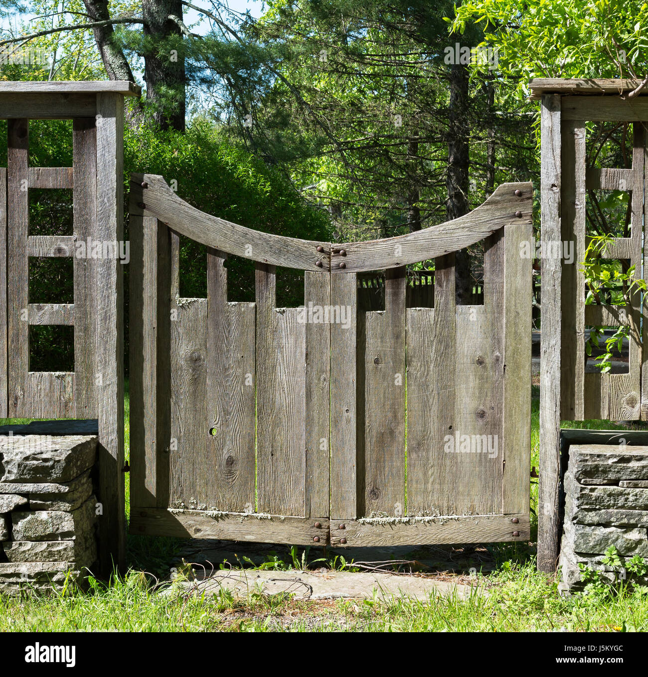 Distressed Grey Wood Gate with a Curved Top in Country Setting, with ...
