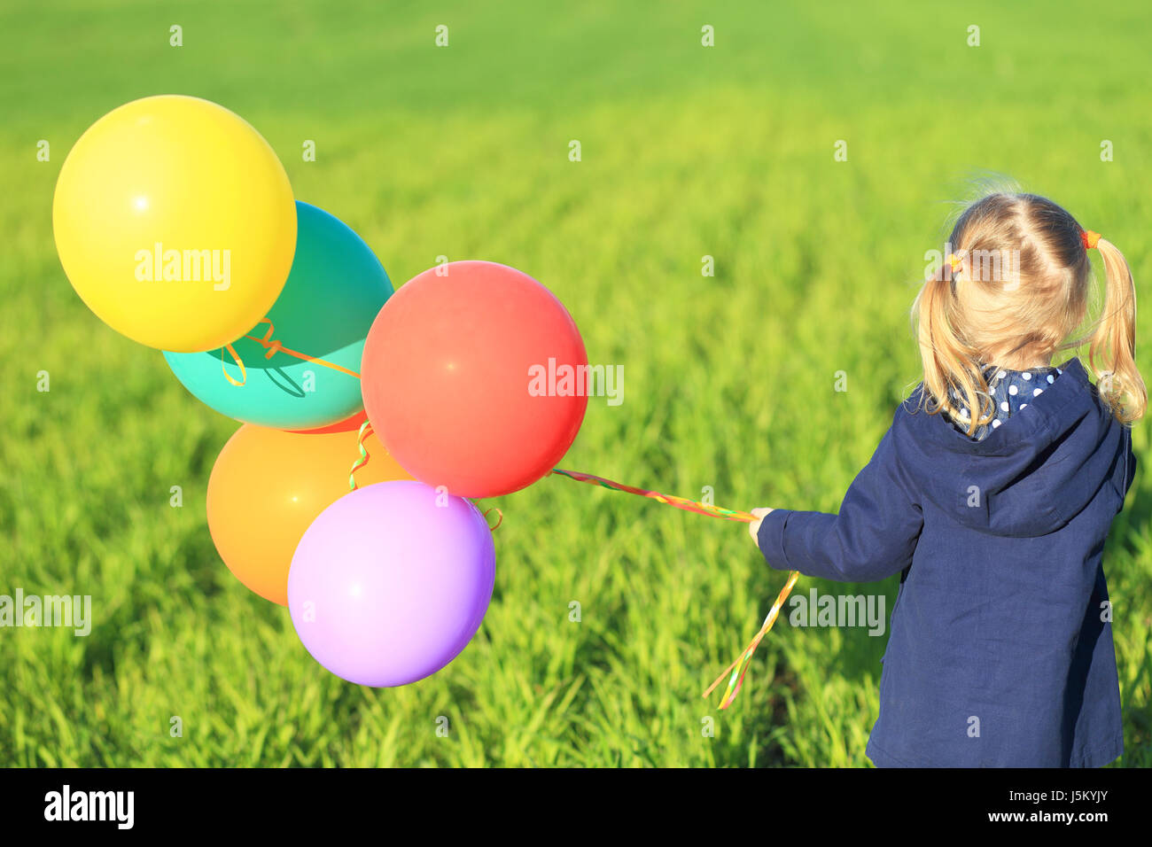 One little girl with balloons close-up. Kid with colorful balloons on ...