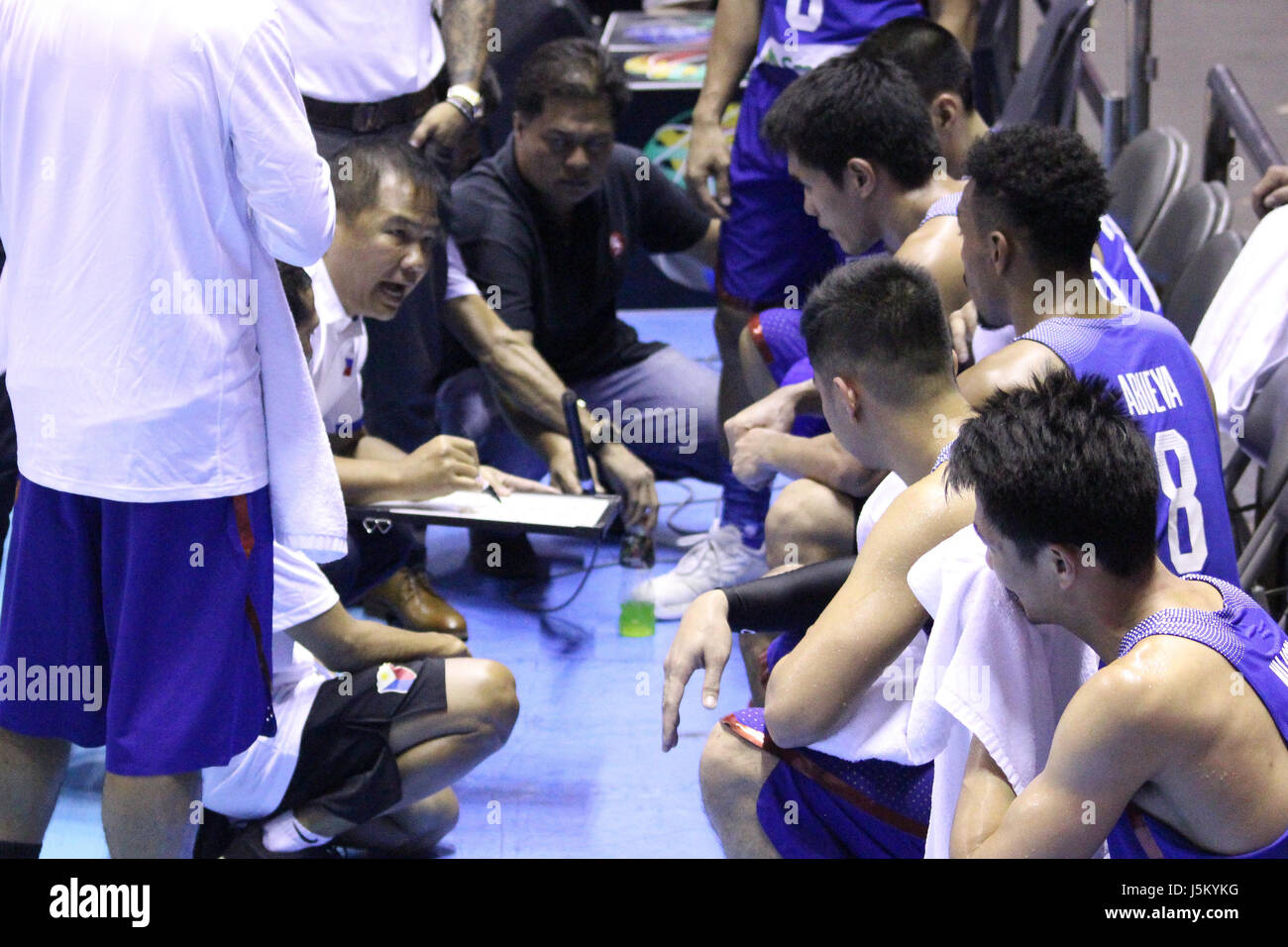 Coach Vincent "Chot" Reyes of the Philippines draws up a play for his ...