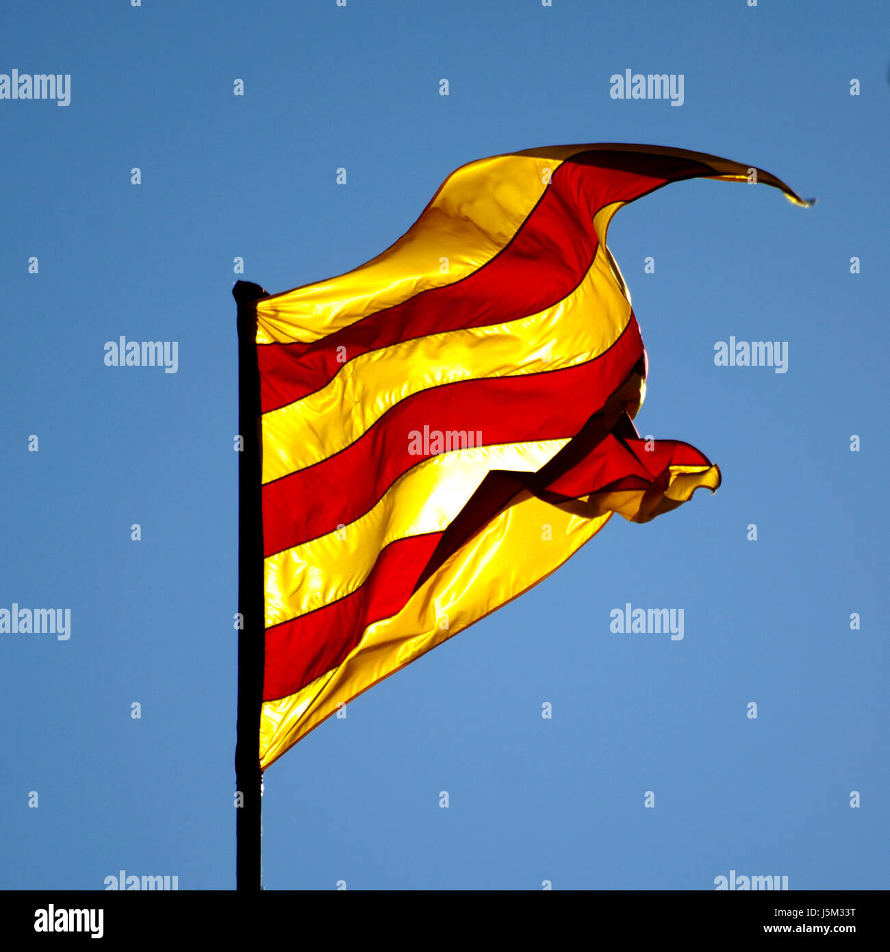 yellow red flag backlit Stock Photo - Alamy