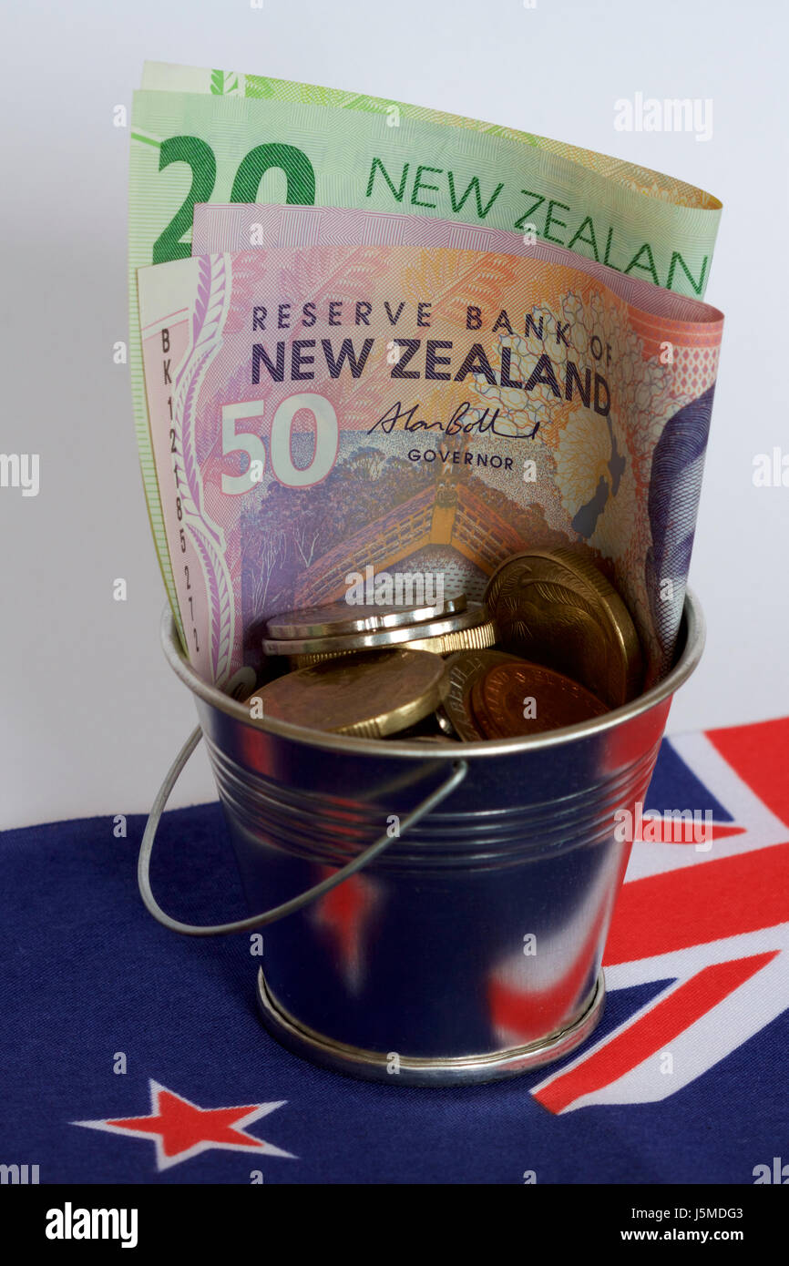 New Zealand money and a bucket Stock Photo - Alamy