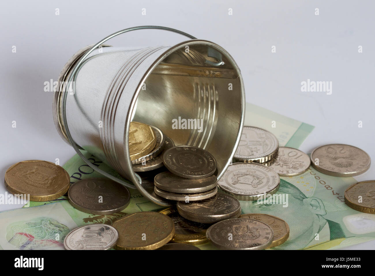 Singaporean money in a bucket Stock Photo - Alamy