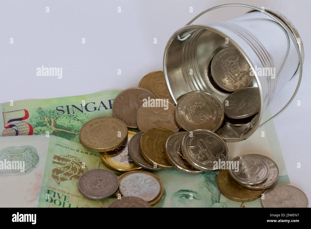 Singaporean money in a bucket Stock Photo - Alamy
