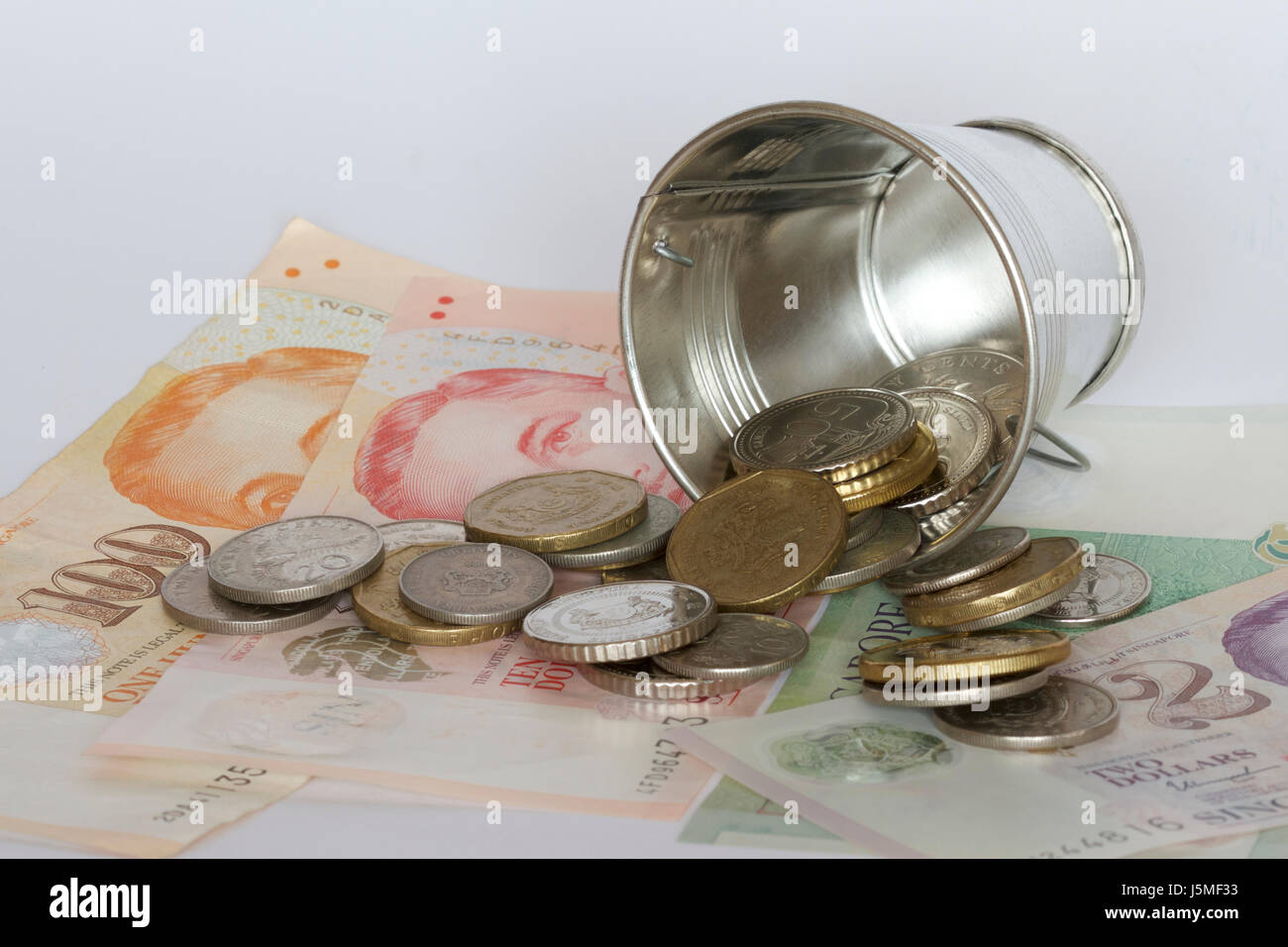 Singaporean money in a bucket Stock Photo - Alamy