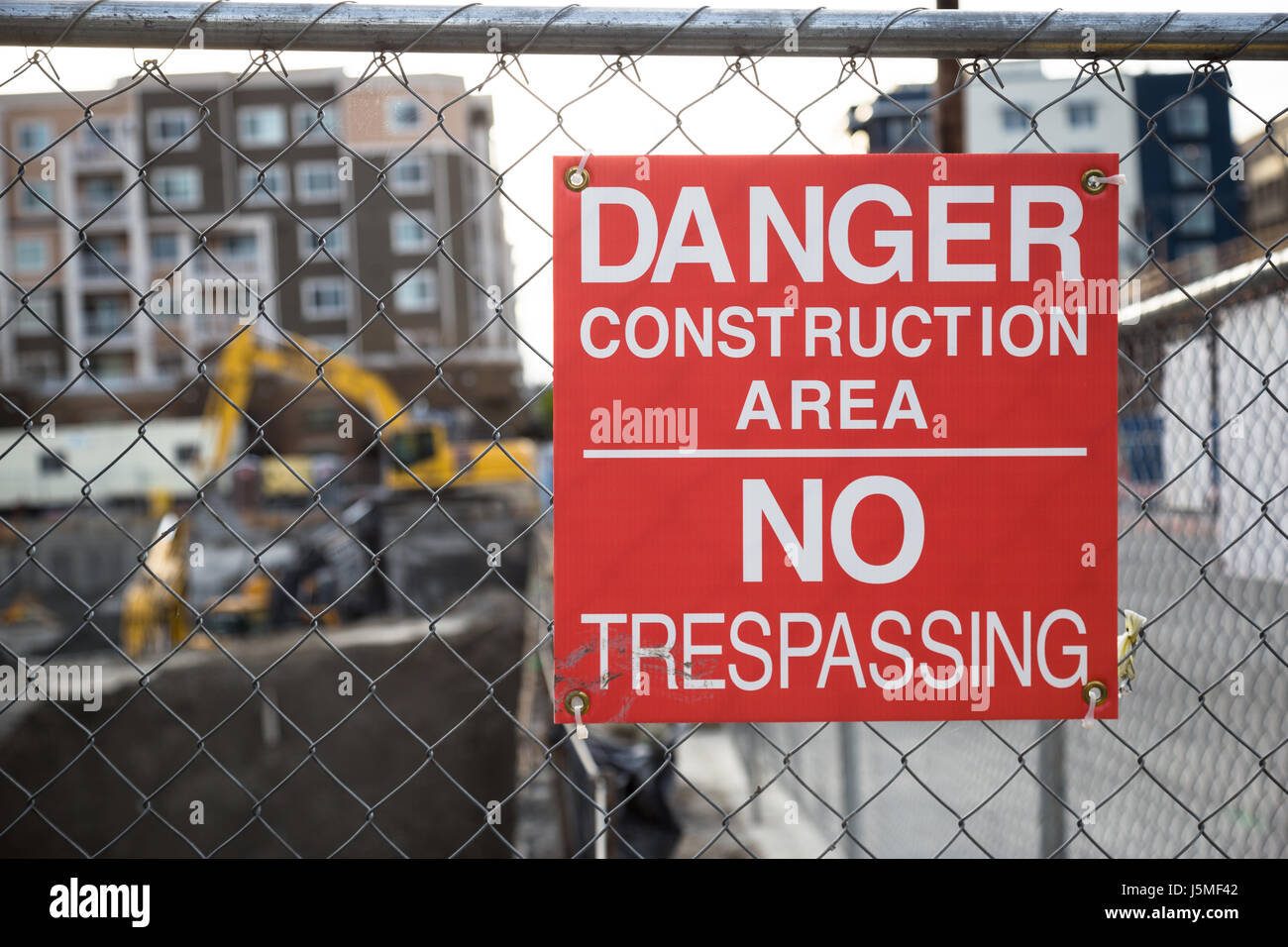 A warning sign at a construction site in Seattle, WA Stock Photo - Alamy