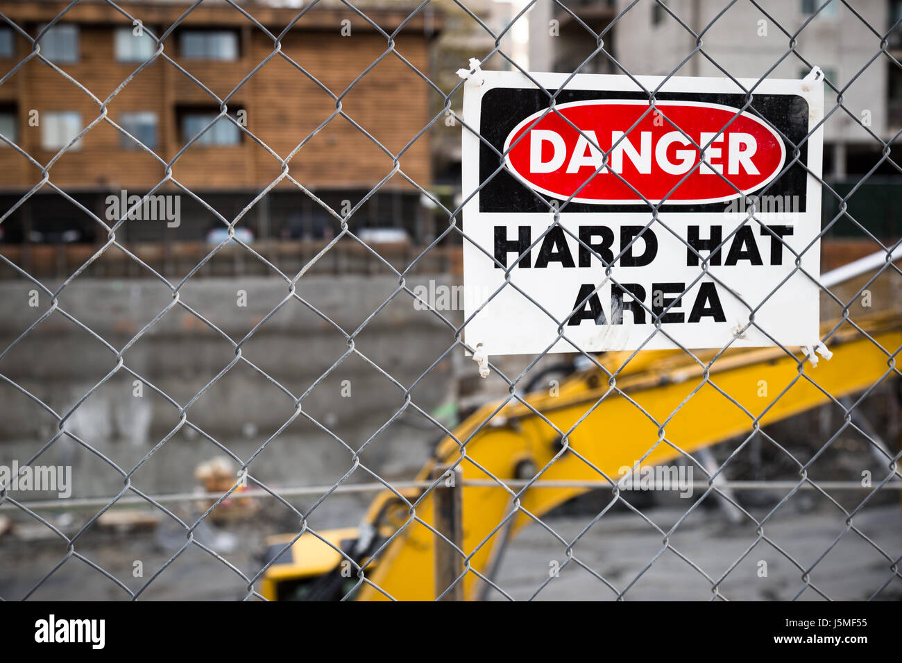 A warning sign at a construction site in Seattle, WA Stock Photo - Alamy