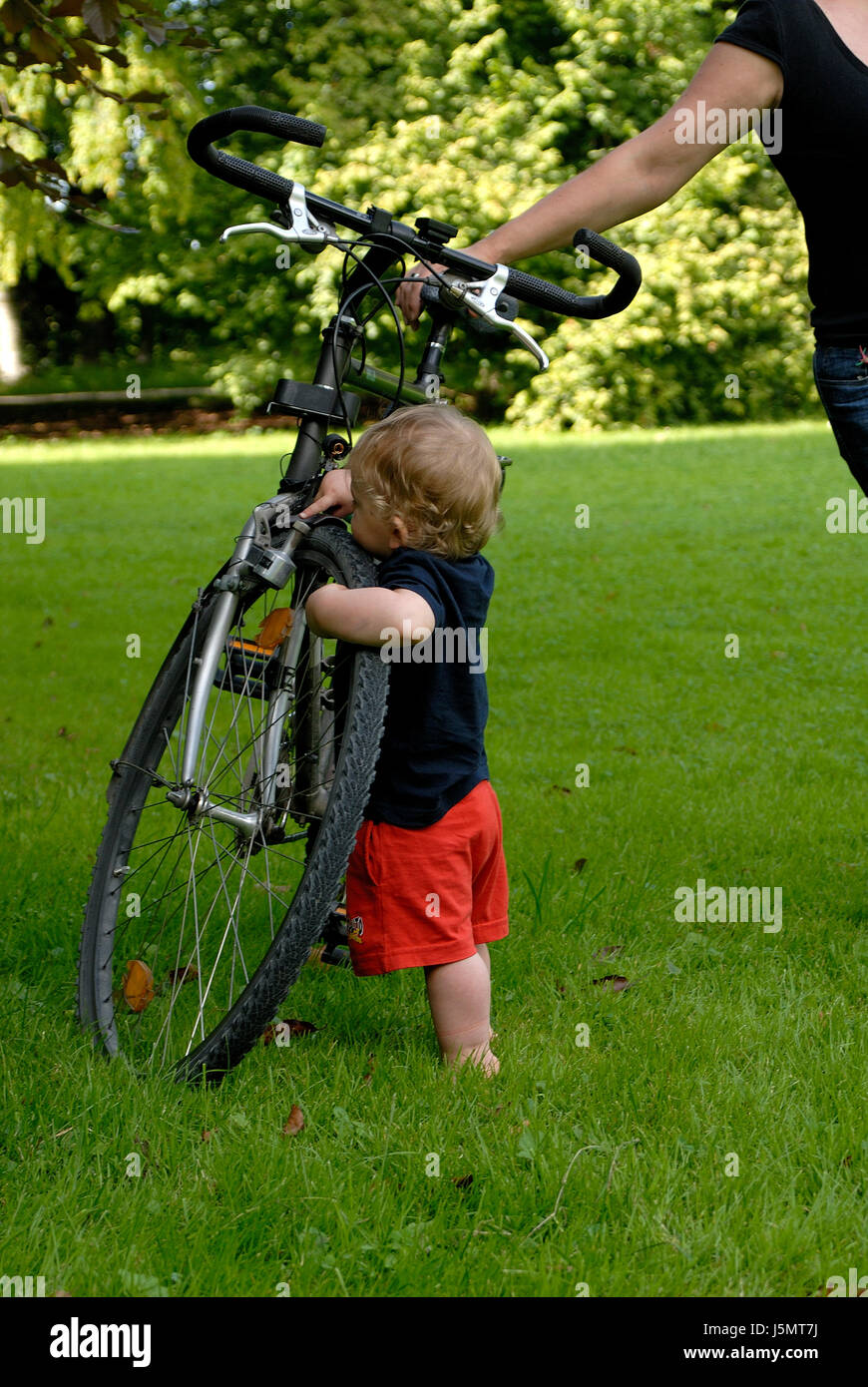 child playing with bicycle Stock Photo - Alamy