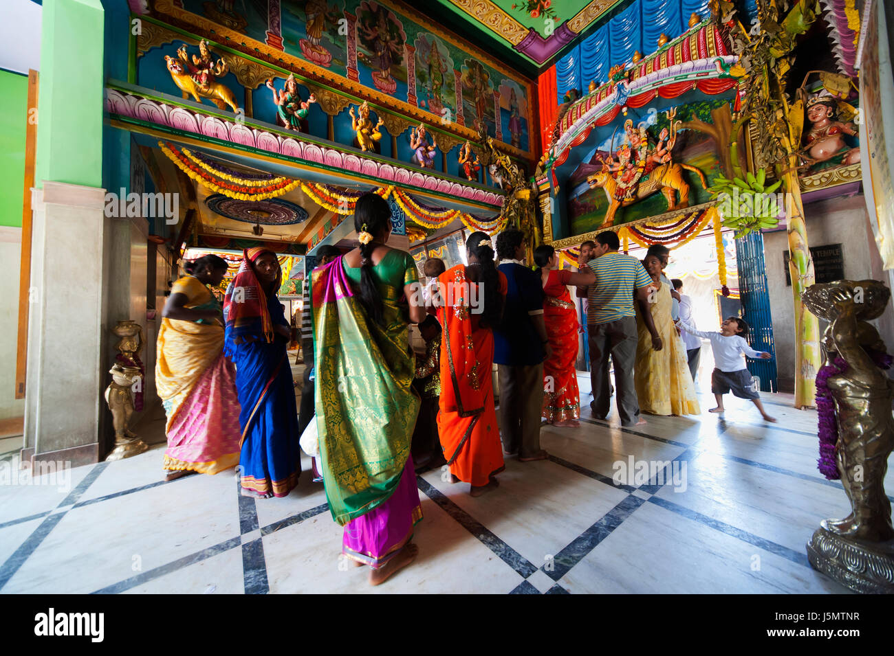 Indian womans in traditional clothes at a temple in Bangalore ...