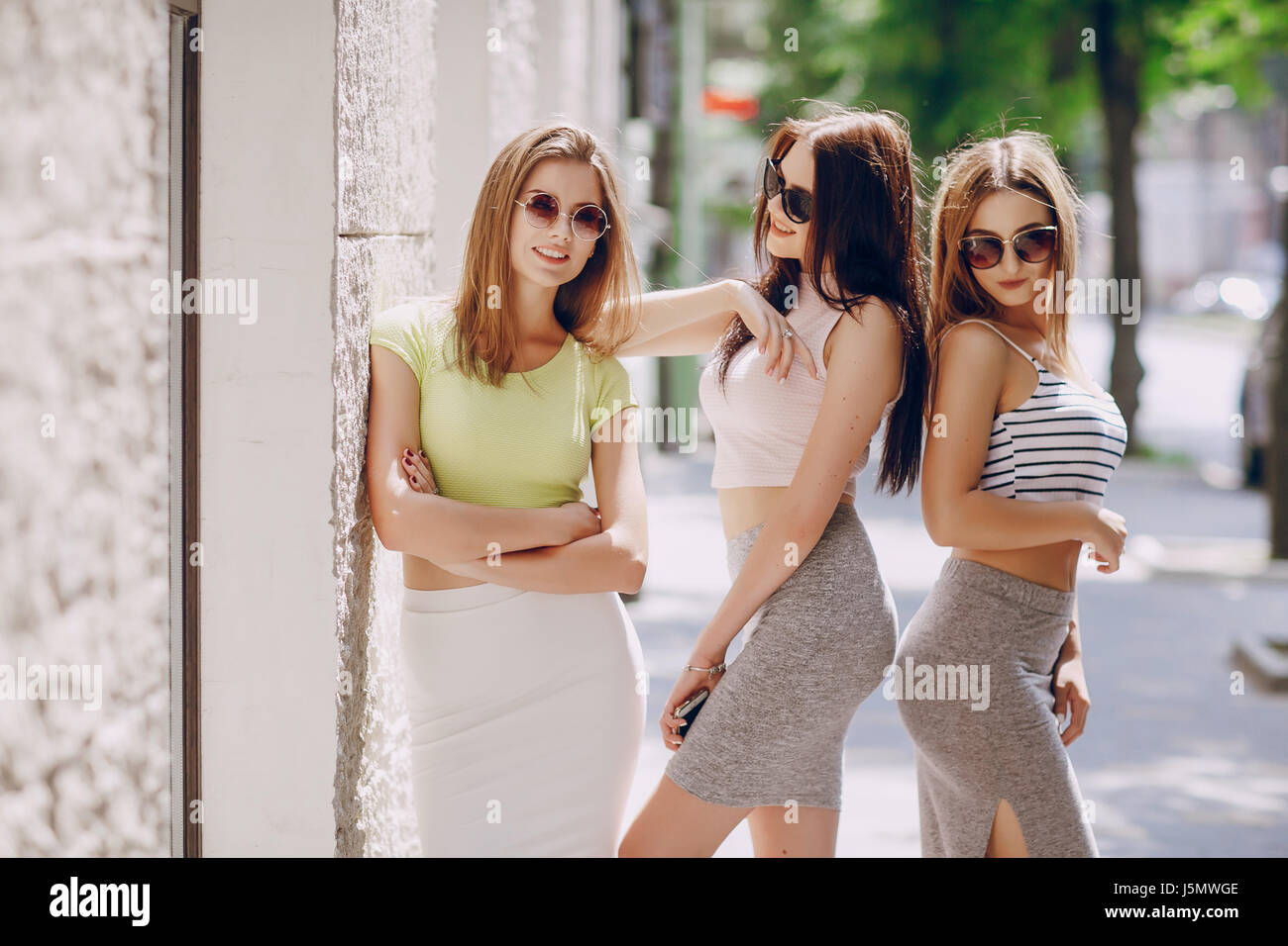 three beautiful girls walking around the city Stock Photo - Alamy
