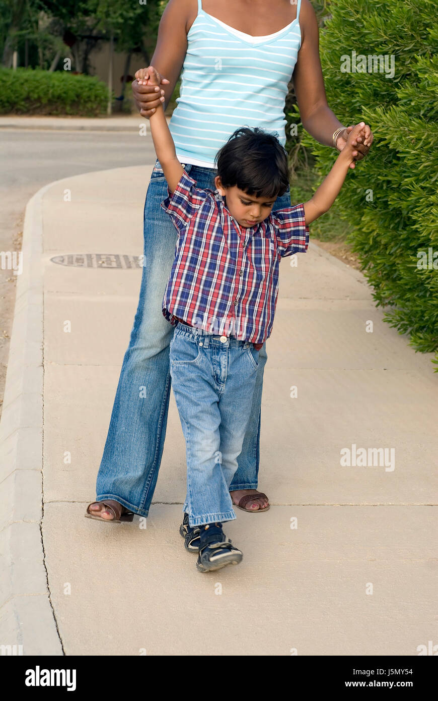 woman walk go going walking hand hands steps step learn hold curb means ...