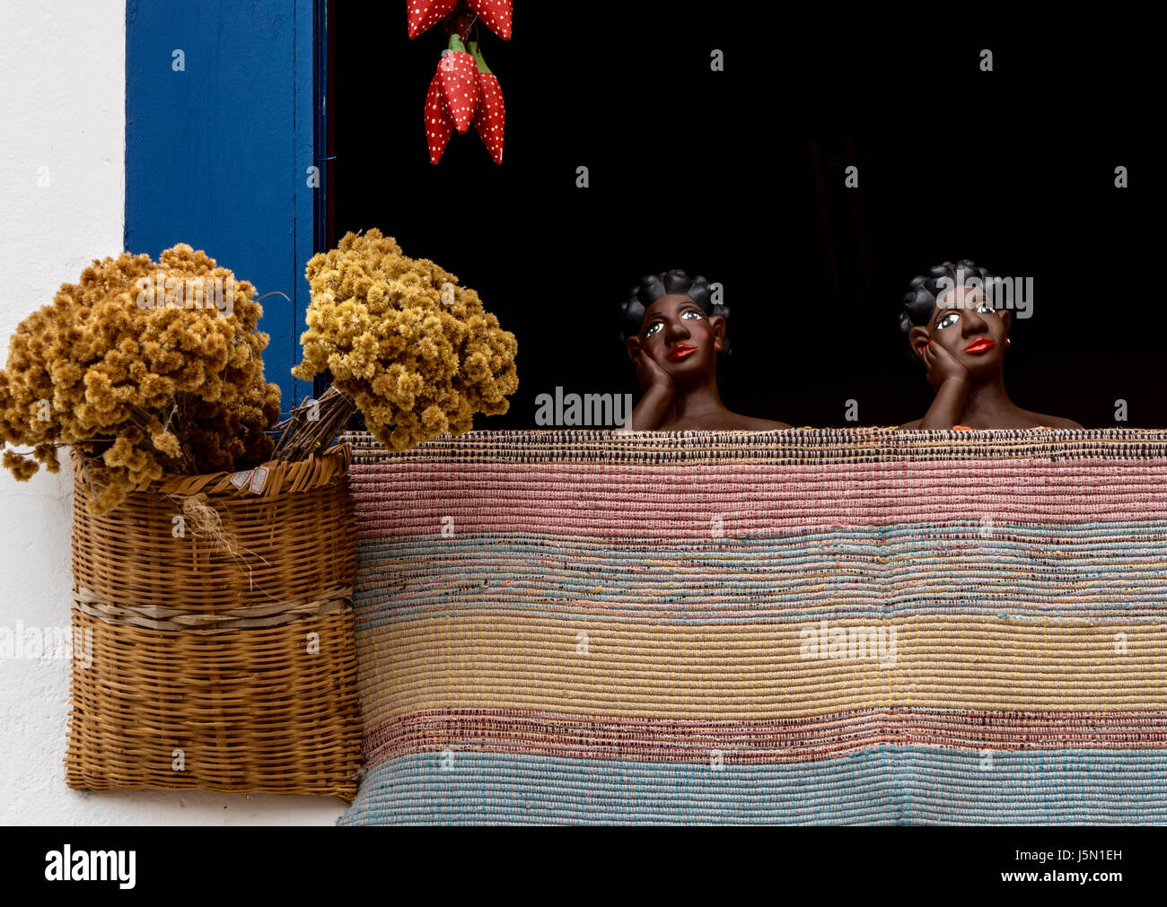 Window display of ceramic lady figures in traditional costumes in Ouro ...