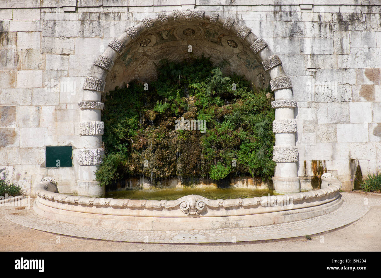 Green fountain in a semicircular niche in the wall of San Pedro de ...