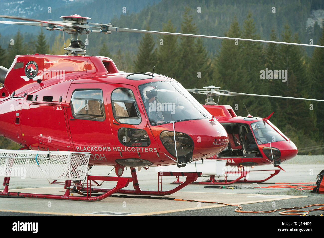 A-350 A-Star helicopters drop water from bucket slung underneath during ...