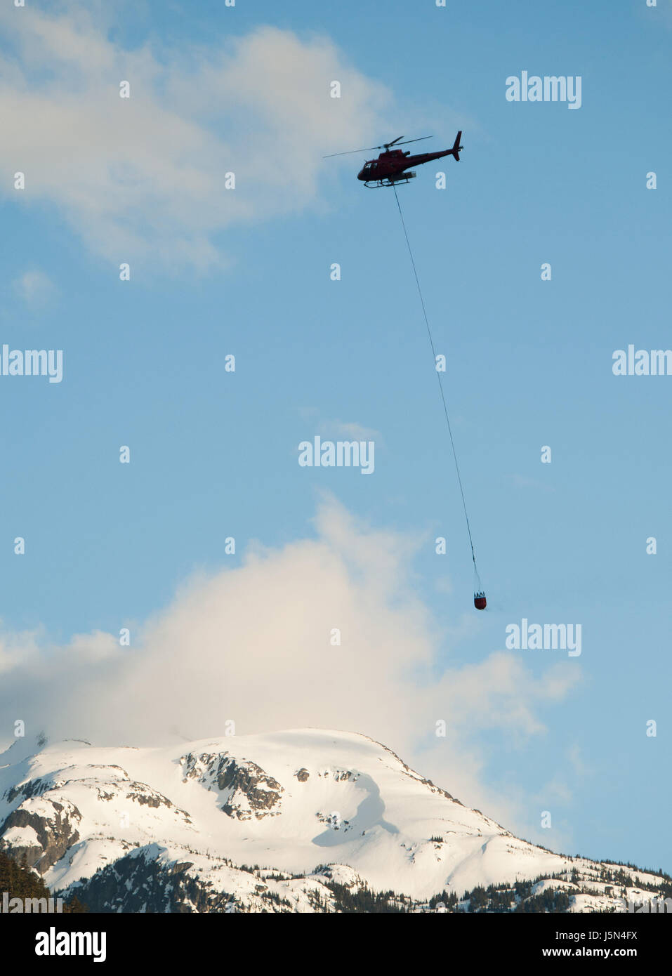 A-350 A-Star helicopters drop water from bucket slung underneath during ...