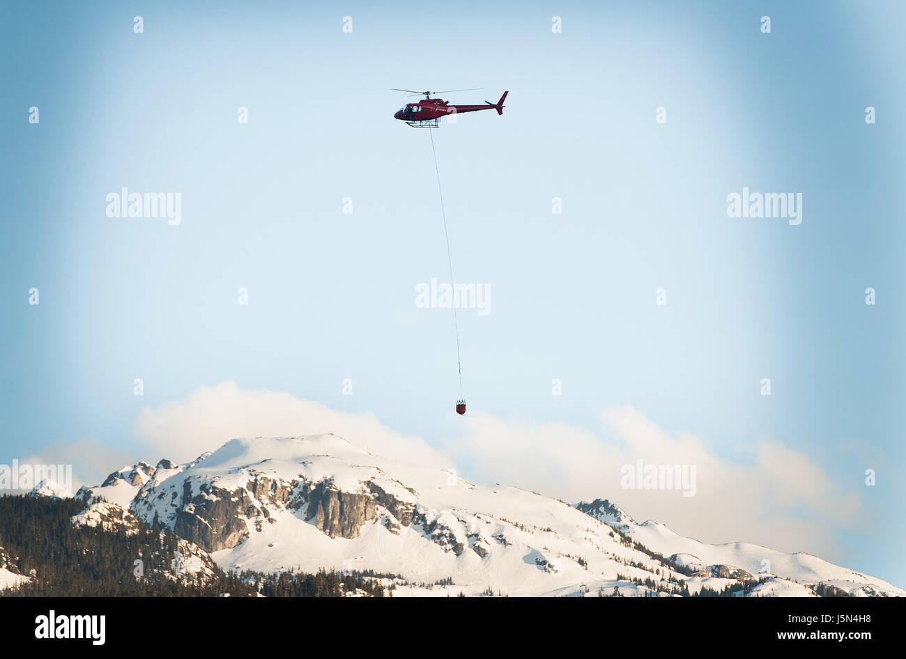 A-350 A-Star helicopters drop water from bucket slung underneath during ...