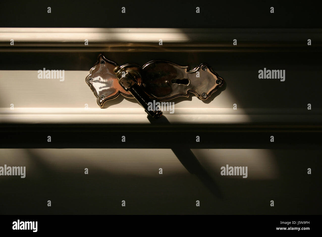 entrance door sunlight brass exit handle keyhole shaddow shadow shadows ...