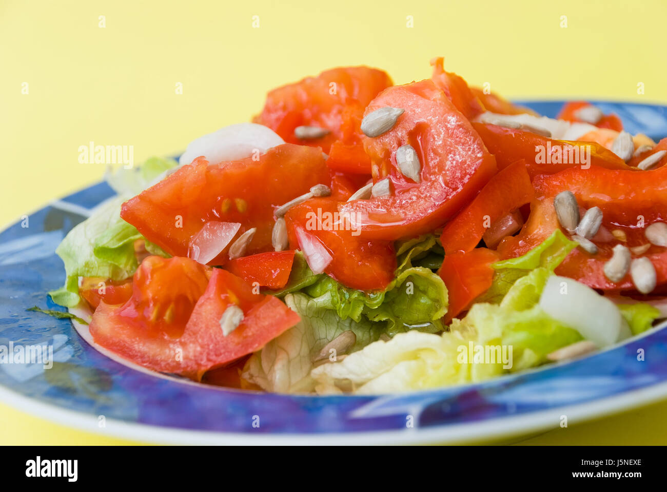 tomato salad with sunflower seeds 4 Stock Photo - Alamy