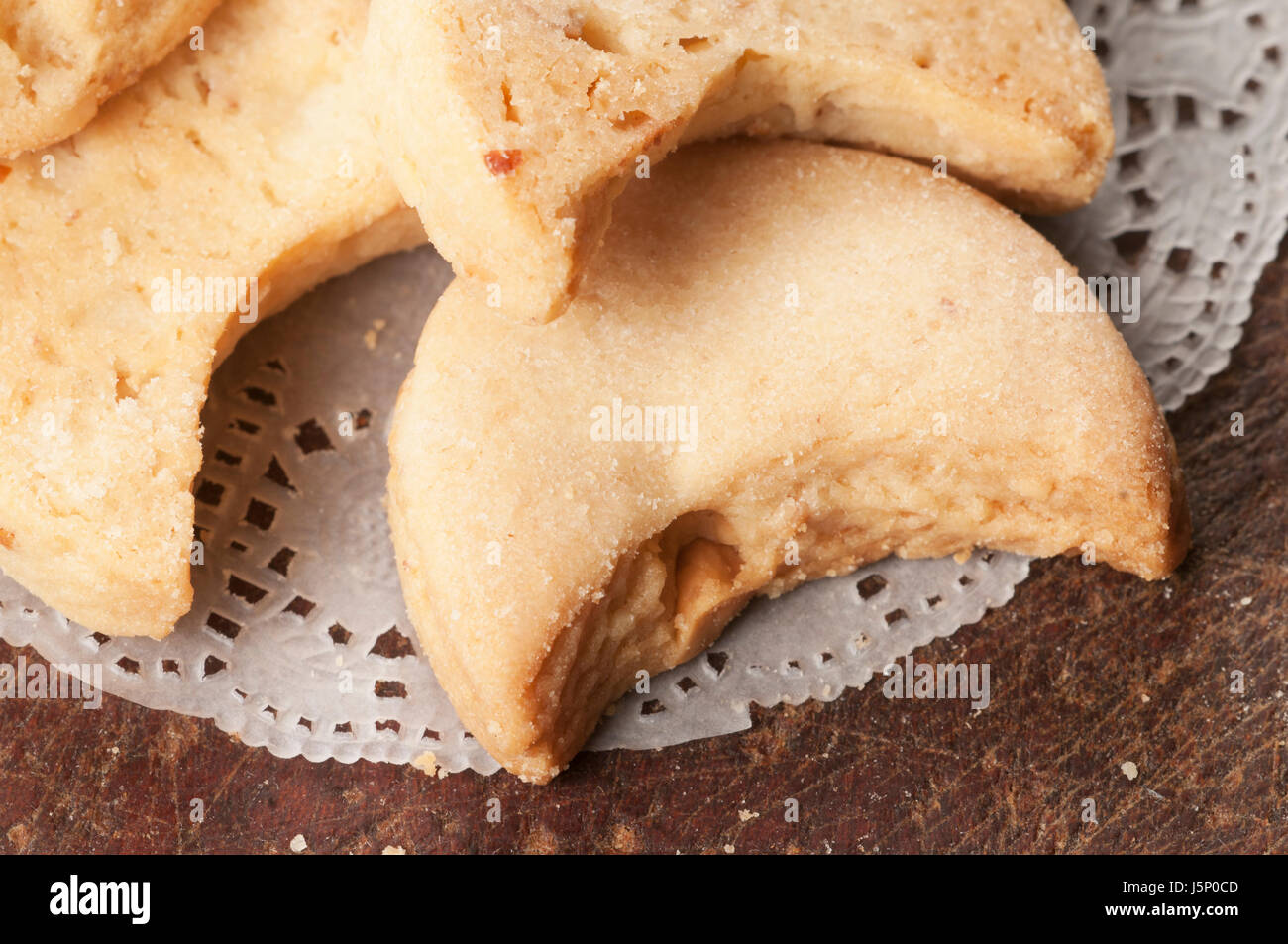 Half moon pastry with peanut on a timber board, close up Stock Photo ...
