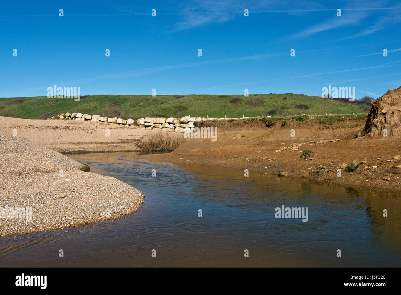 The River Bride crossing the beach and meeting the sea at Burton ...