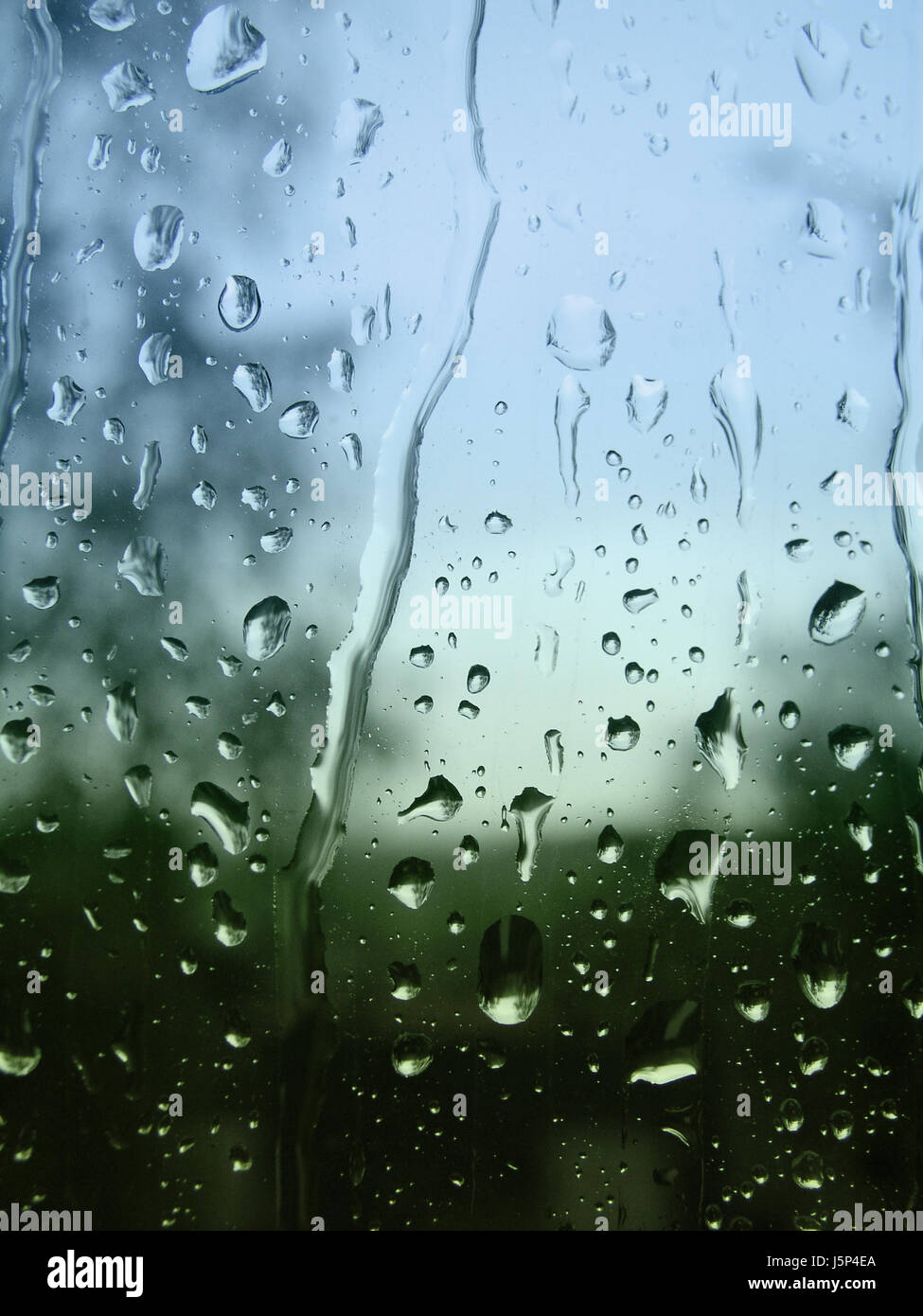 blue green window porthole dormer window pane cold raindrop ...