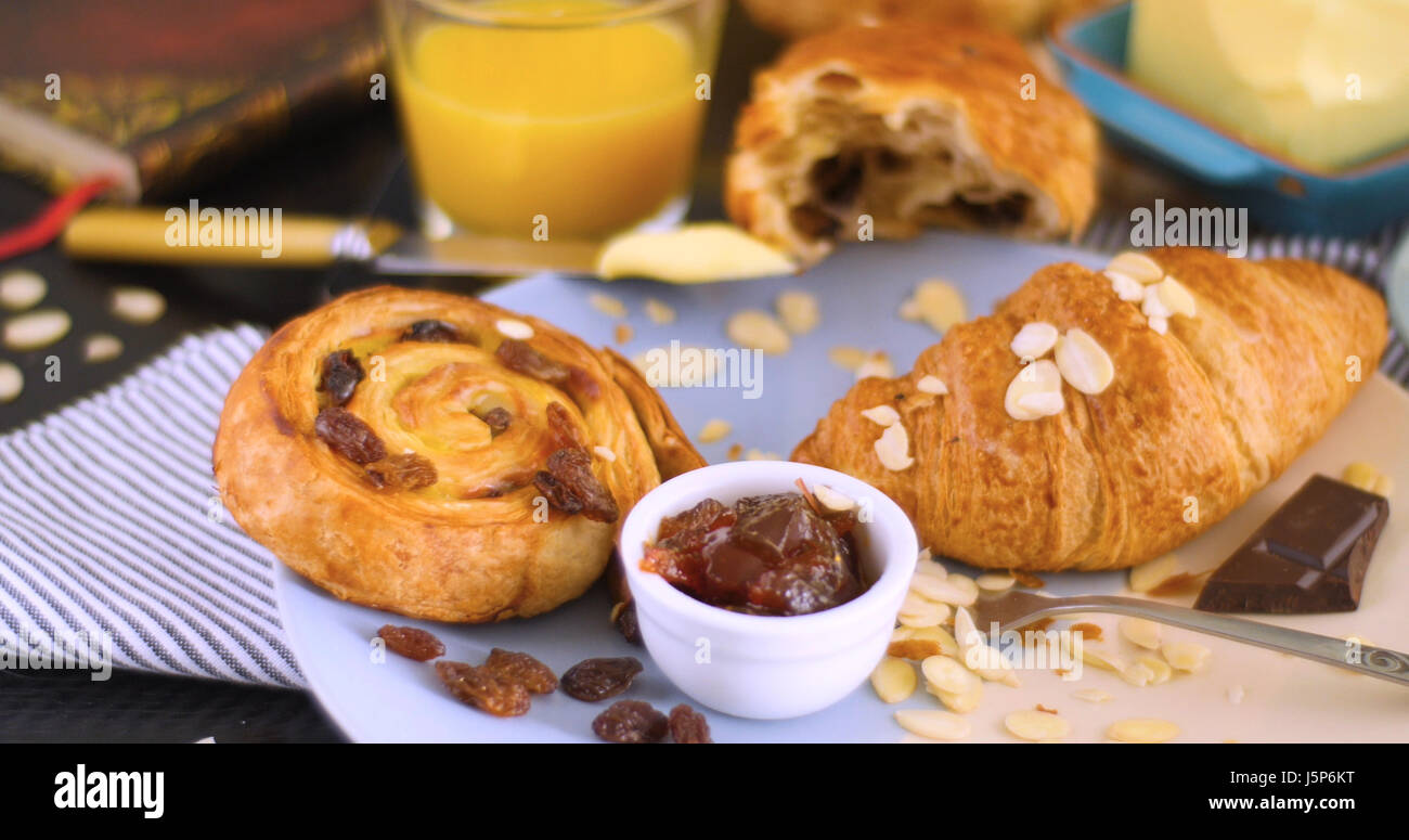 View of a French breakfast with pastries and orange juice, defocused ...