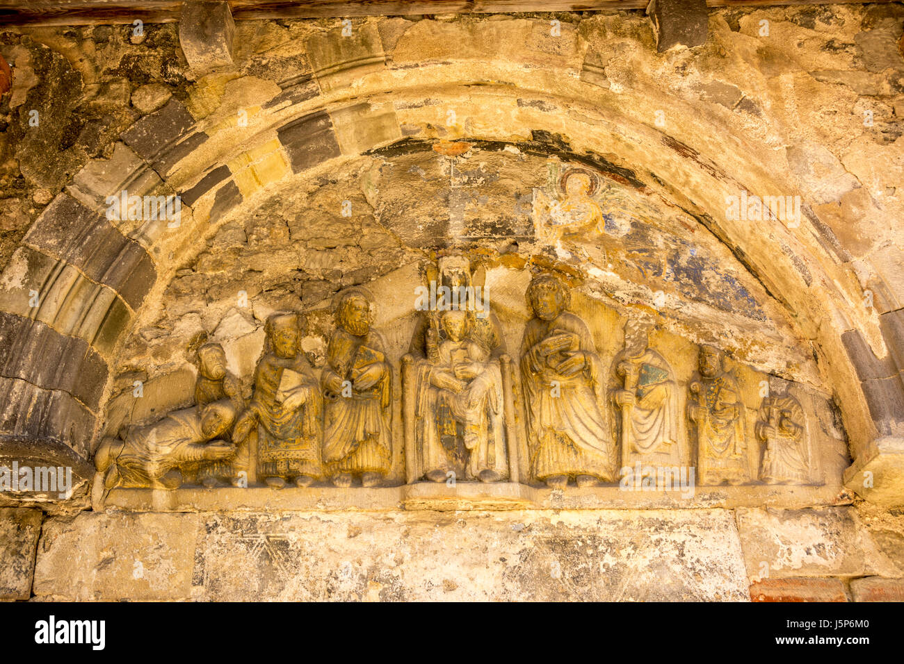 Tympanum of Mozac church. Puy de Dome. Auvergne. France Stock Photo - Alamy