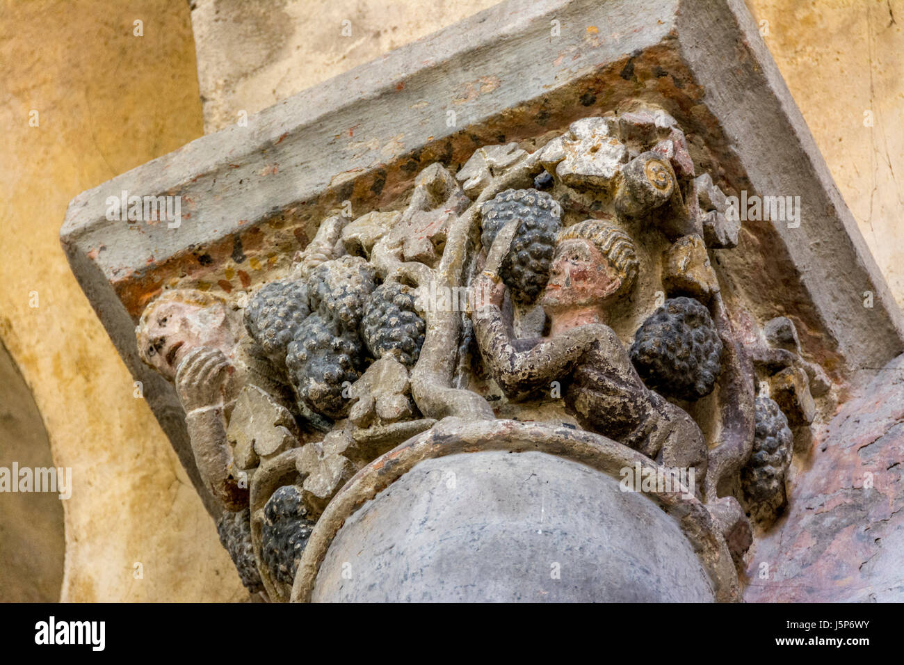 Mozac. Capitals of Saint-Pierre Abbey Church outdoors. Puy de Dome ...