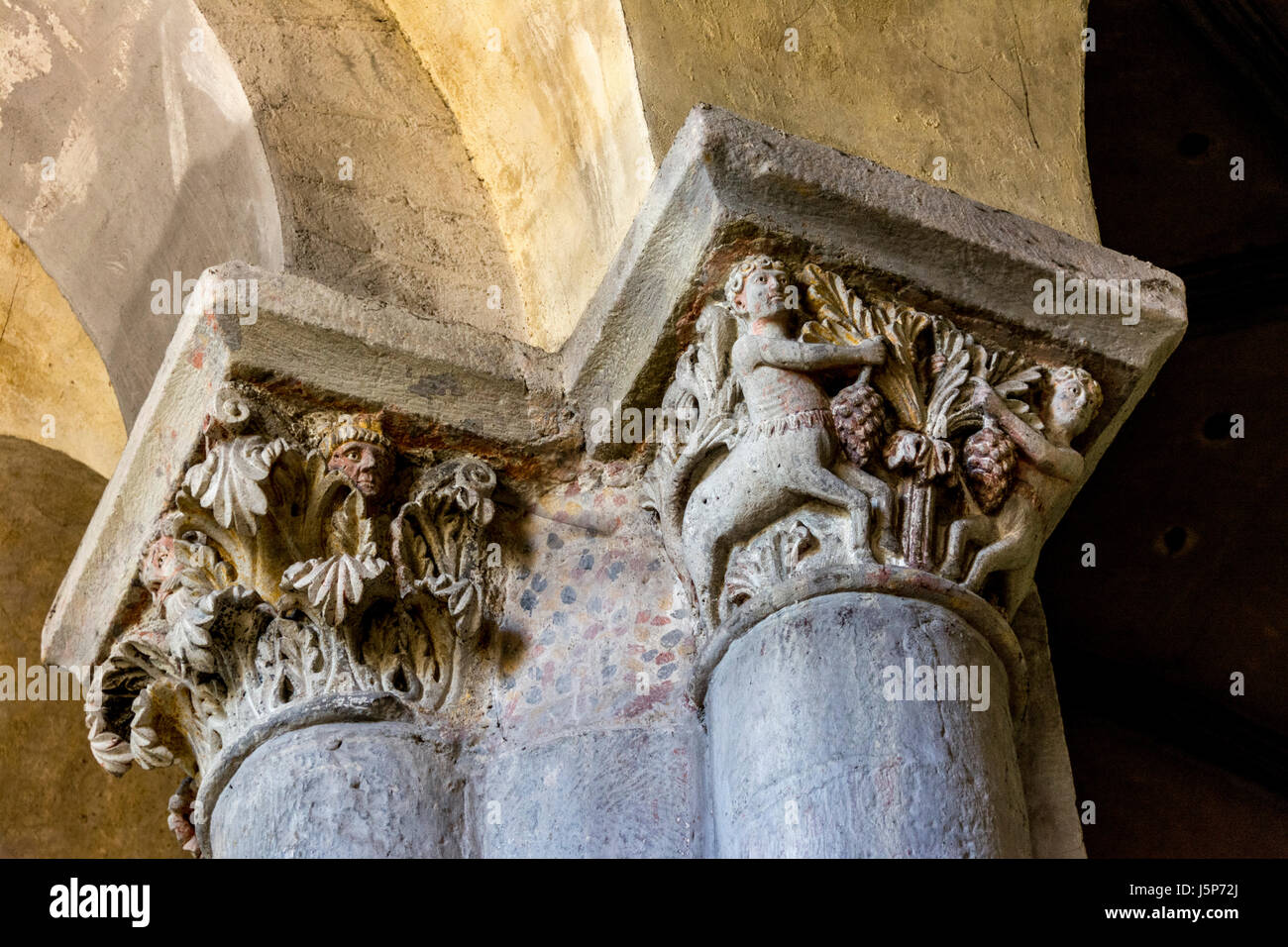 Mozac. Capitals of Saint-Pierre Abbey Church outdoors. Puy de Dome ...