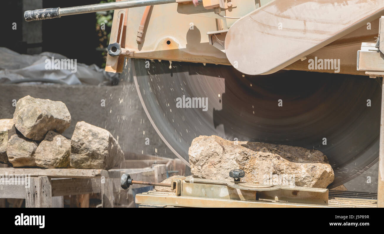 man cutting a stone with a water saw on a renovation site Stock Photo ...