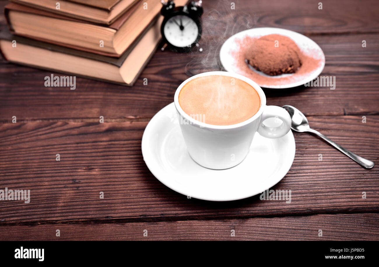 Cup of hot espresso, behind stack of books, top view Stock Photo - Alamy