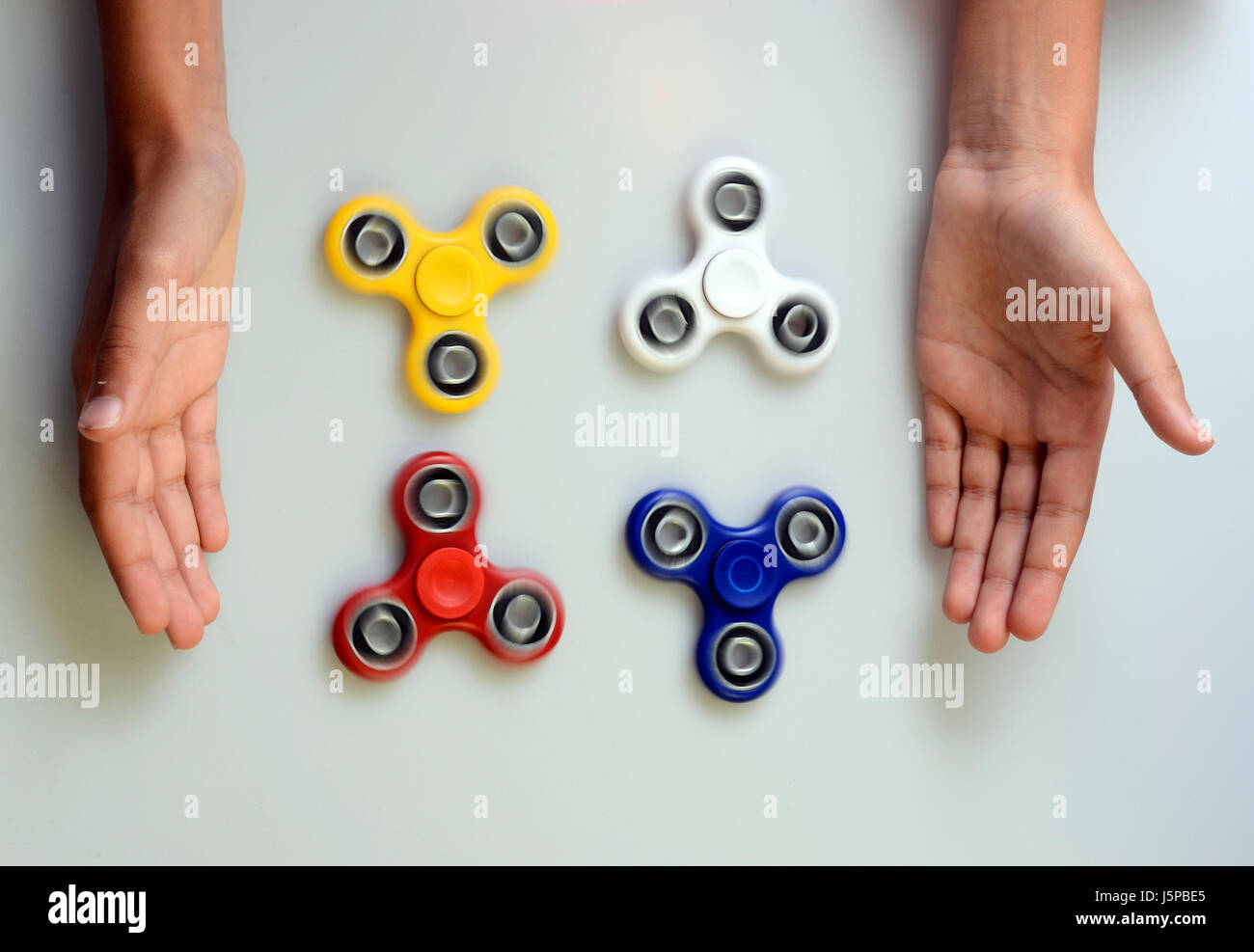 Four colored Hand spinner, fidgeting hand toy Stock Photo - Alamy Four colored Hand spinner, fidgeting hand toy Stock Photo - Alamy