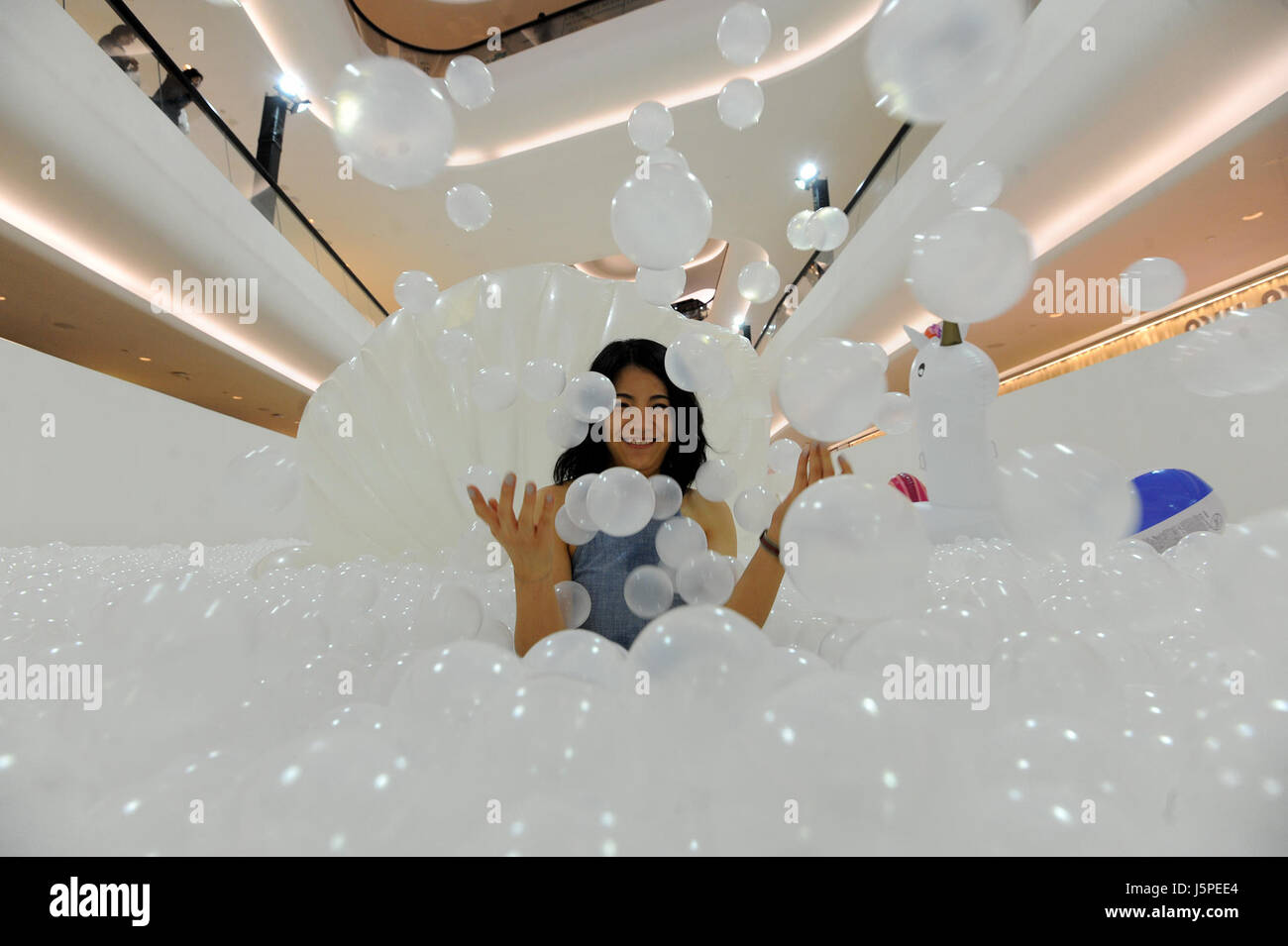 Bangkok, Thailand. 18th May, 2017. A woman plays with plastic balls as ...