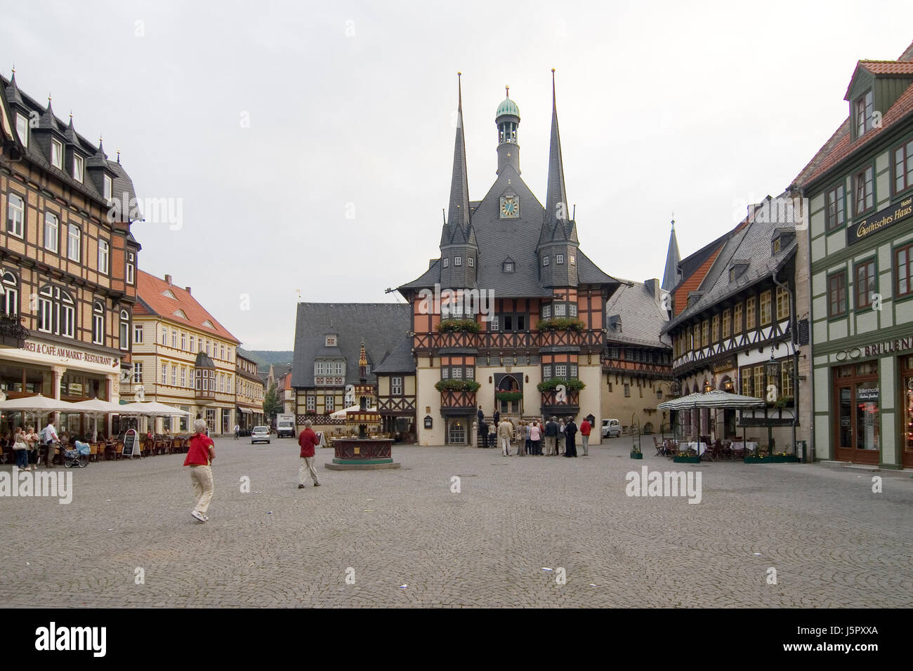 passersby historical old town frame-work town hall square towers style ...