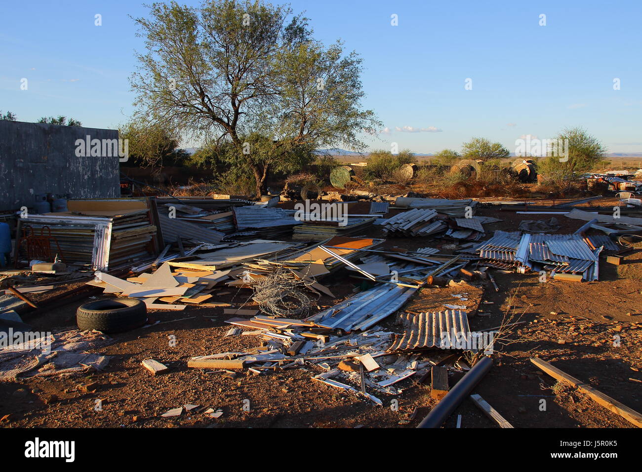 Rubble from a destroyed homestead litter the countryside Stock Photo ...