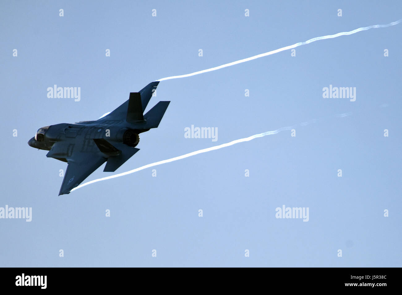 A USAF F-35 stealth fighter aircraft takes off from the runway during ...