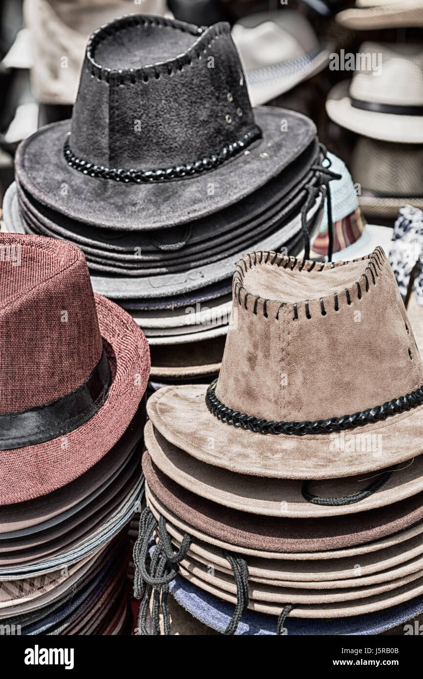 in a old market lots of colorated hats like background clothes Stock ...