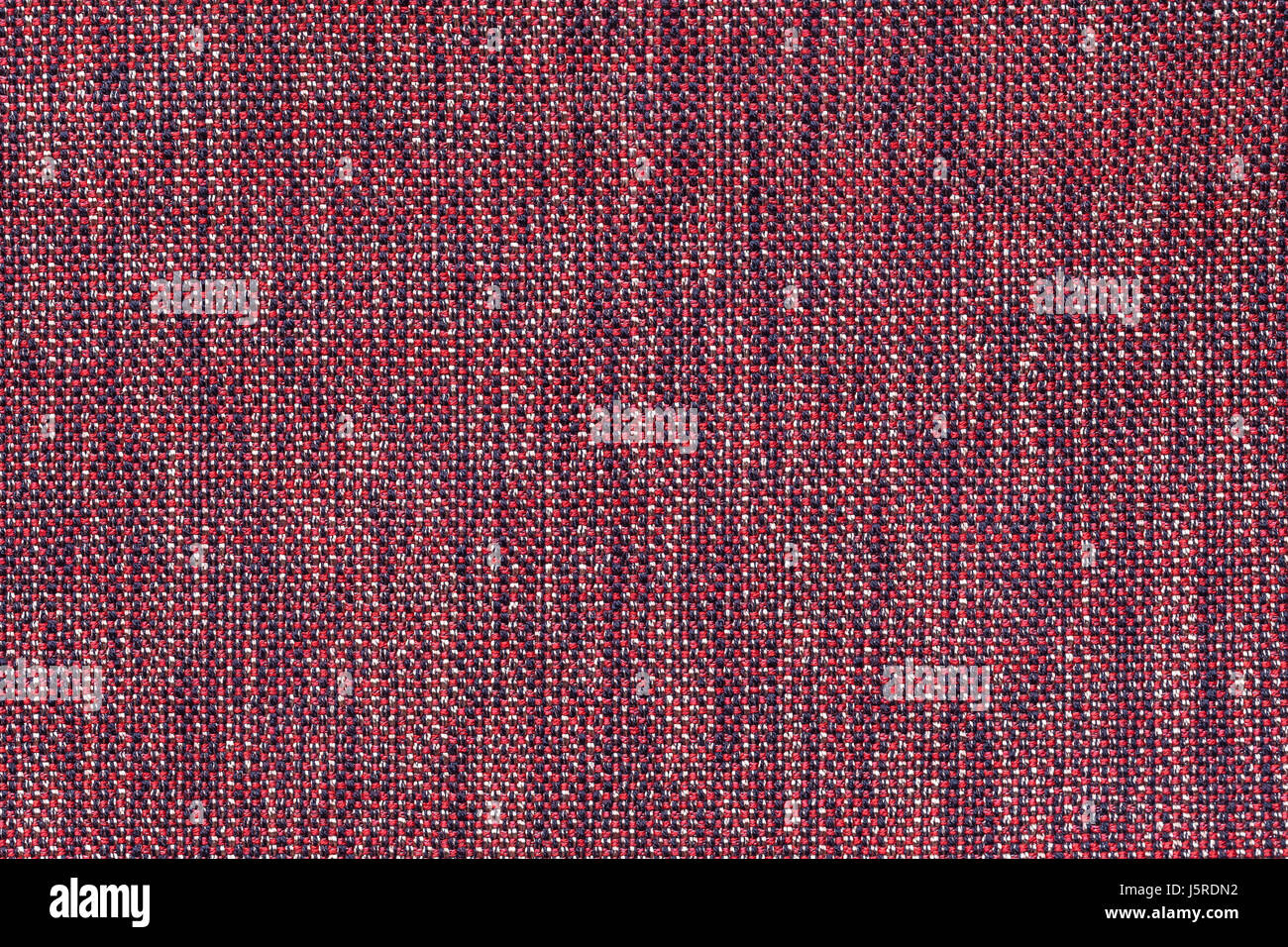 Dark red background with checkered pattern, closeup. Structure of the ...