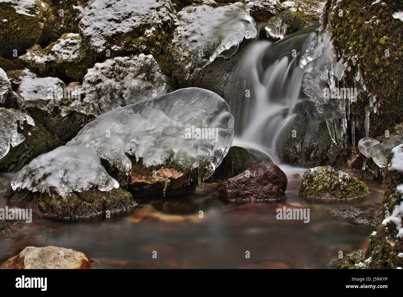 stream waterfall ice frozen icy current of the river snow water nature ...