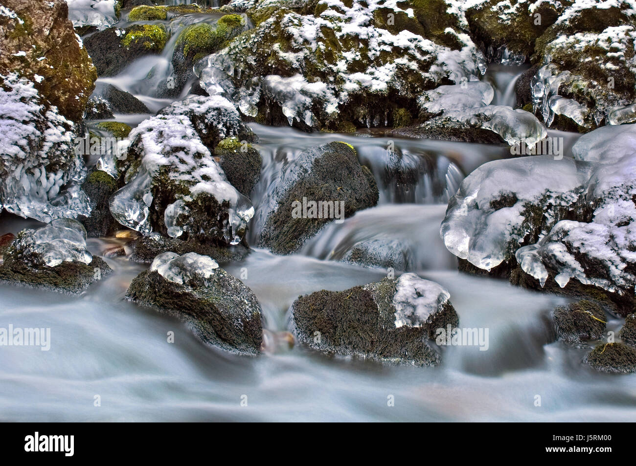 stream waterfall ice frozen icy current of the river snow water nature ...