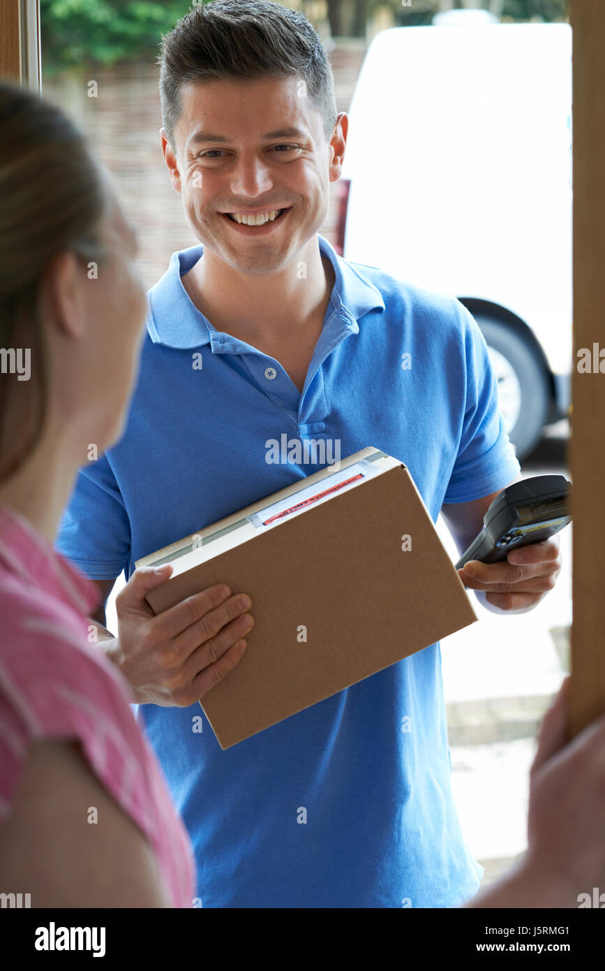 Courier Delivering Package To Domestic House Stock Photo - Alamy